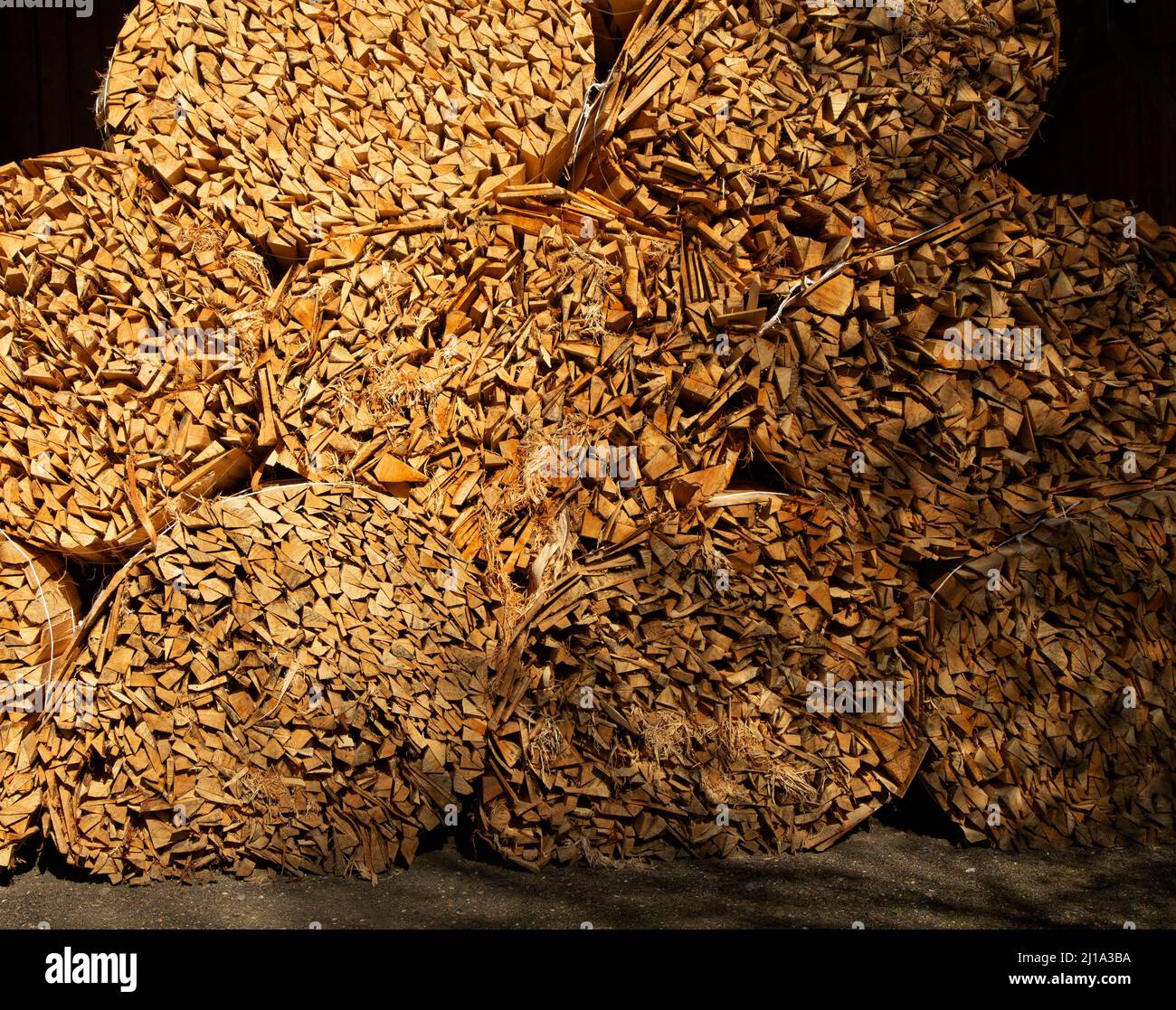 Bundles of wood offcuts at a willow sawmill, Suffolk, England, UK Stock ...