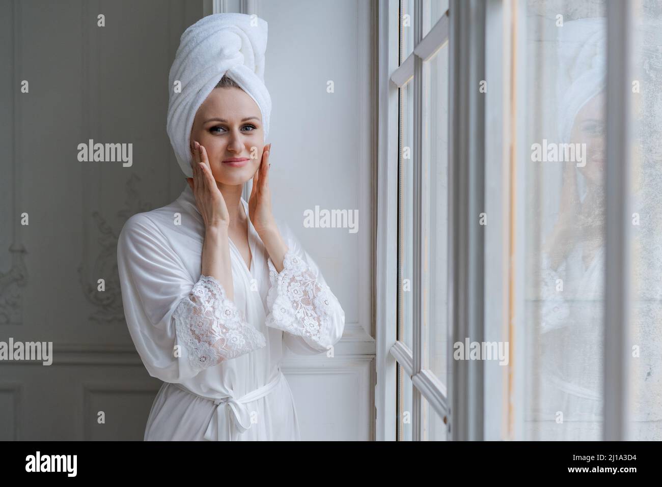 Portrait gorgeous young woman wearing white silk robe and turban towel ...