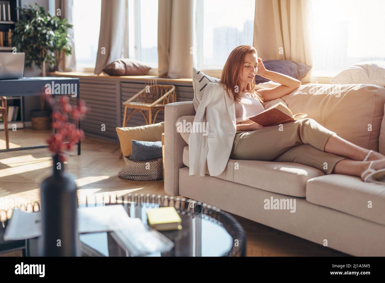 Reading literature. Woman at home with a book Stock Photo - Alamy