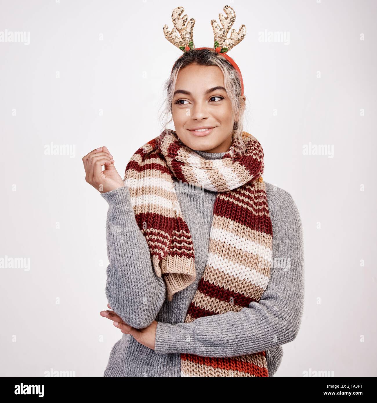 Festive thoughts. Studio shot of an attractive young woman looking ...