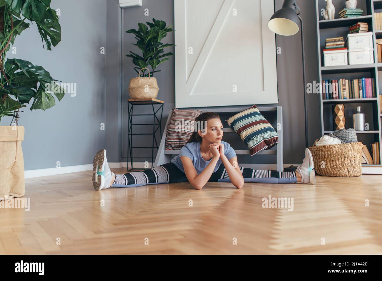 Young fit woman doing the splits working out at home Stock Photo - Alamy