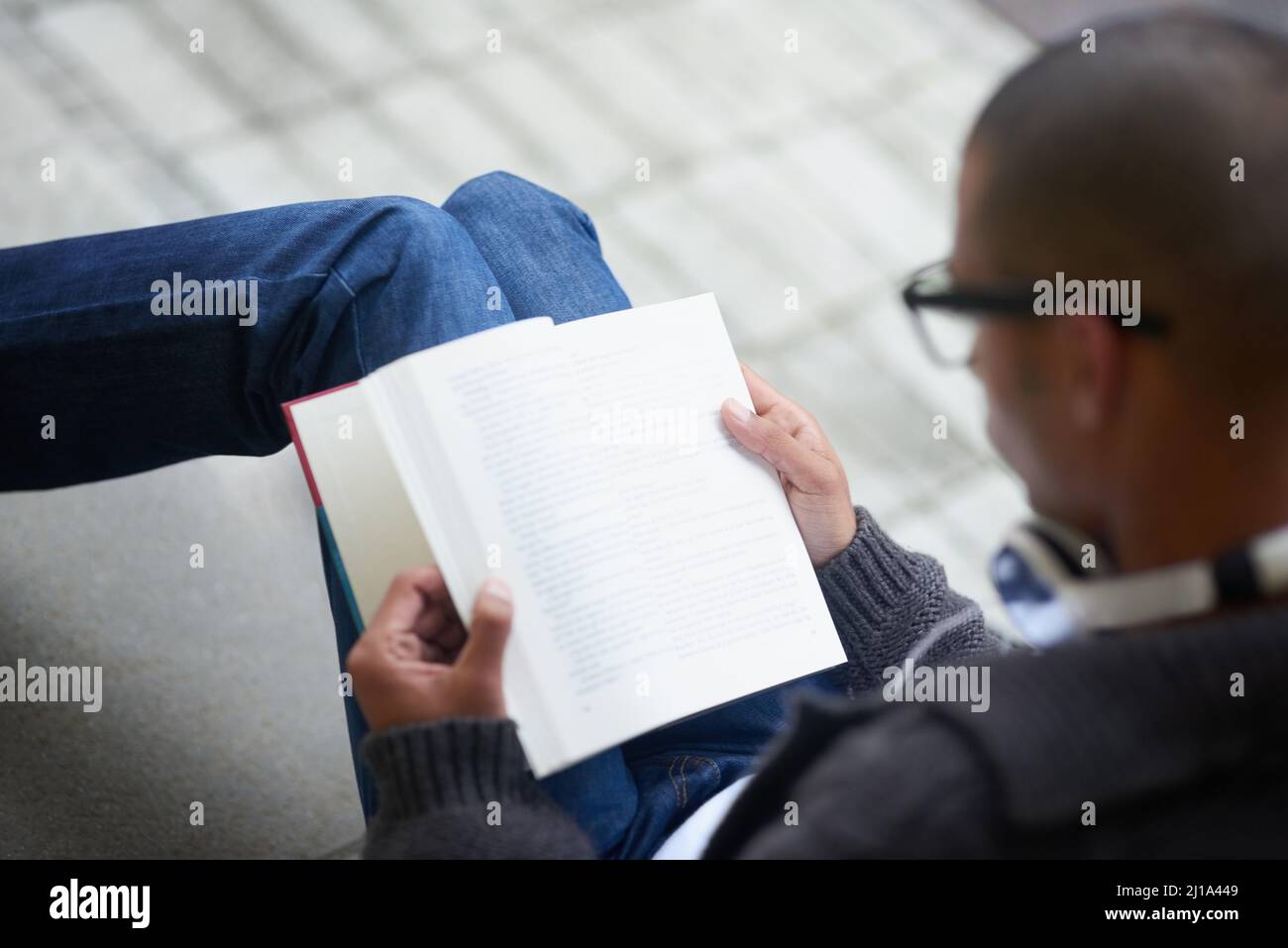 Reading up on notes for his next lecture. Cropped shot of a college ...