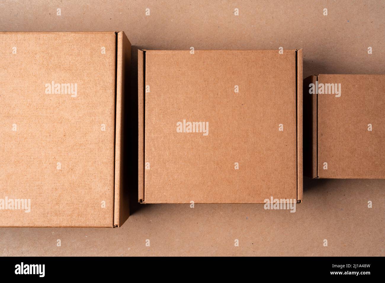 Cardboard box on beige background in studio Stock Photo - Alamy