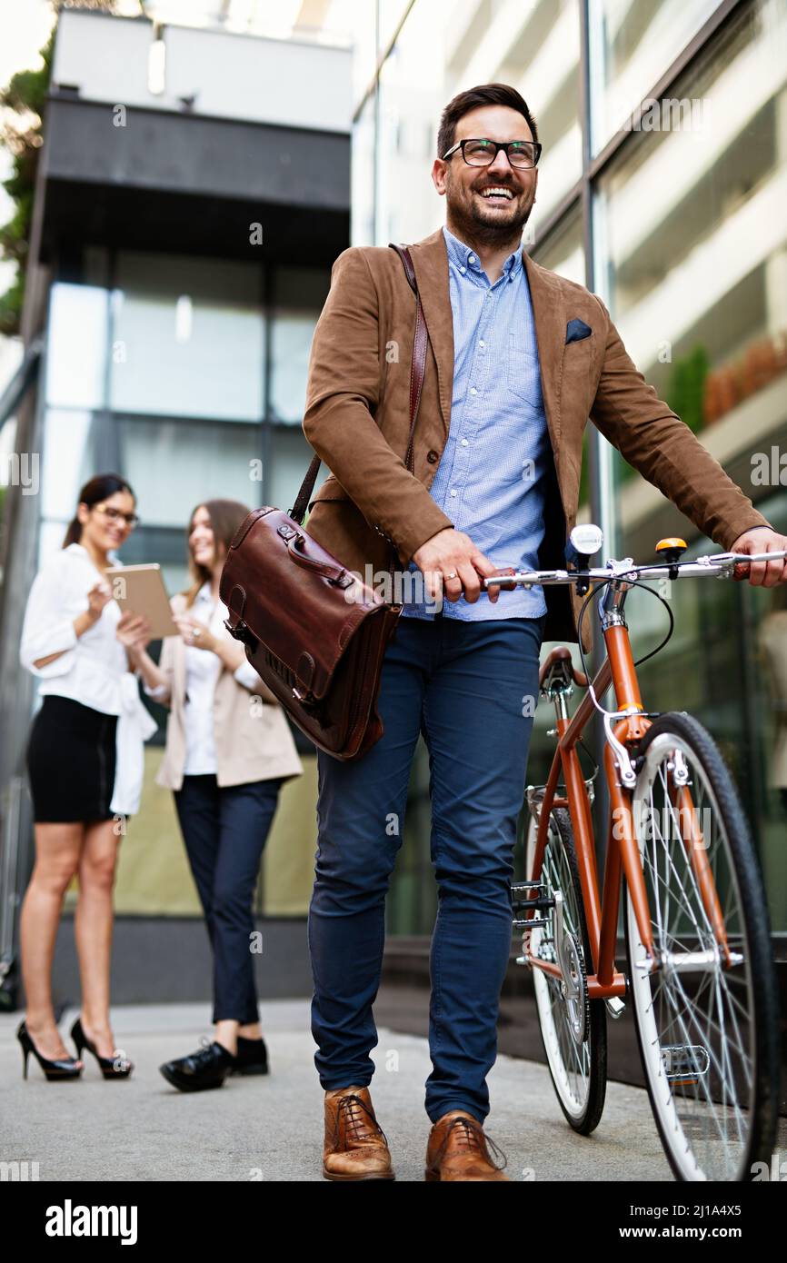 On the way to work. Portrait of happy fit business man with bicycle in ...