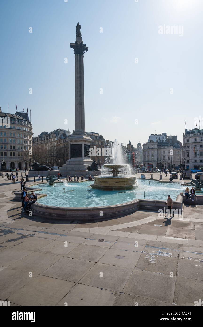 People out and about enjoying a sunny spring day in Trafalgar Square ...