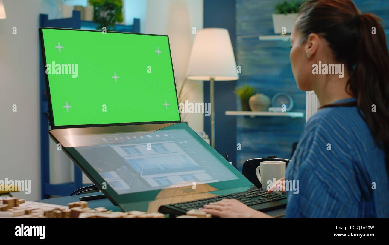 Woman architect using green screen for building model and architectural ...