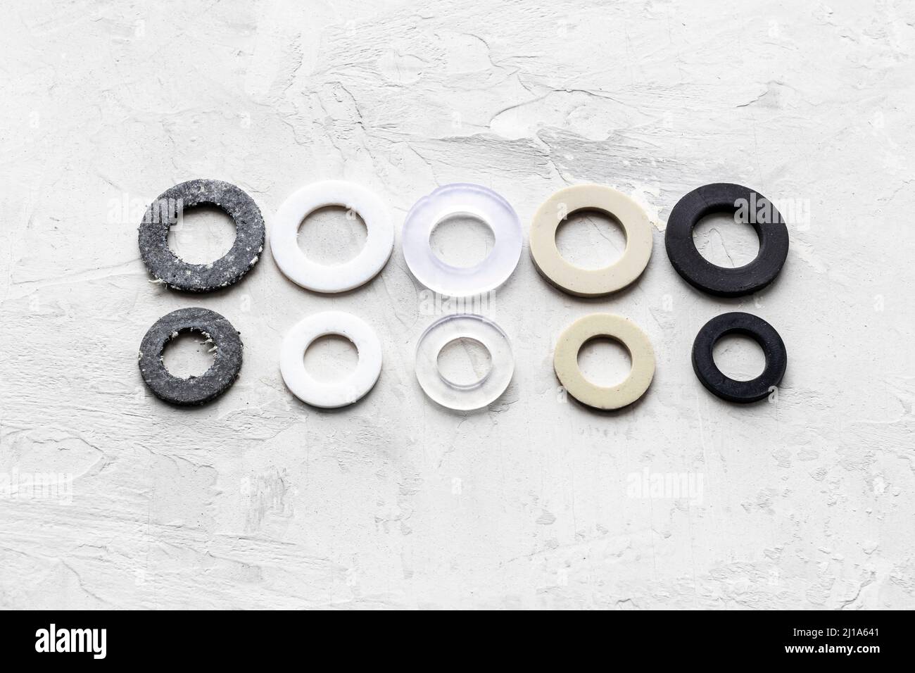 above view of different gaskets for piping water systems on gray ...