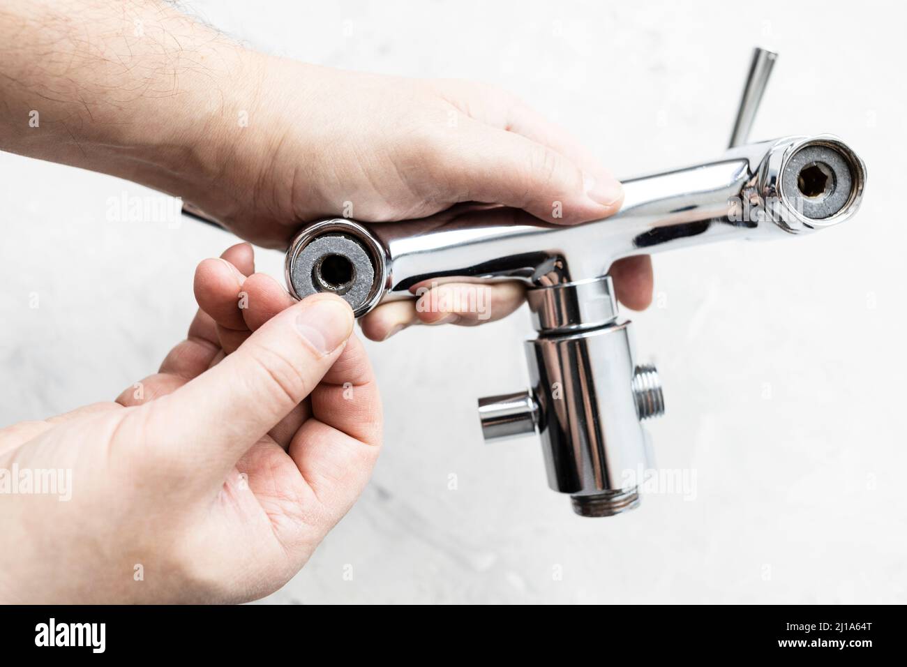 top view of plumber hands install paronite gasket in shower faucet and ...