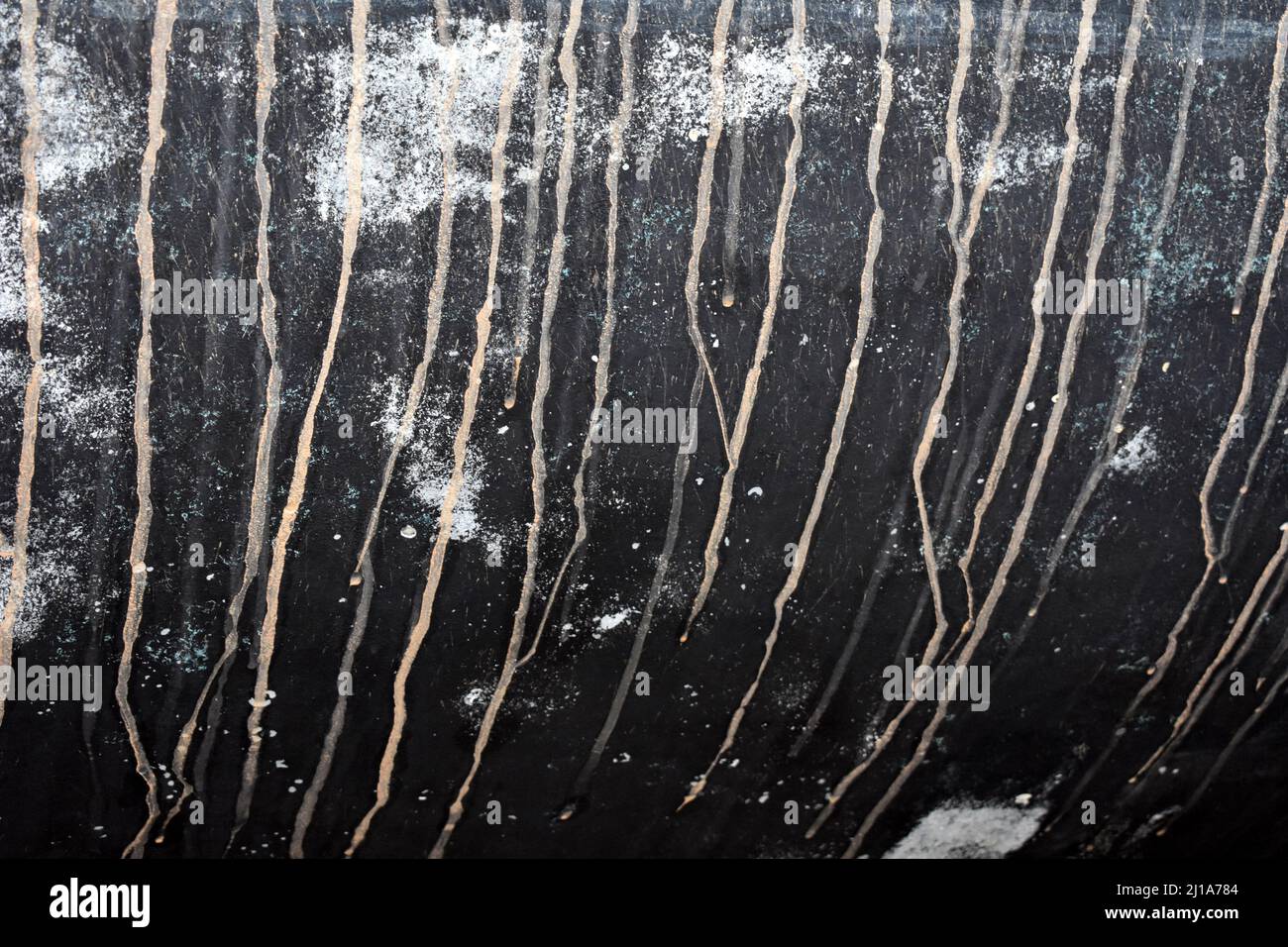 Sandy red rain streaks running down the side and under a yacht ...