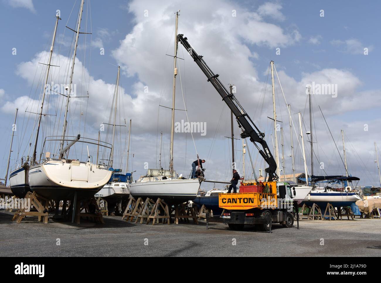 Yacht mast being removed by a crane, Almerimar marina boatyard, Almeria ...