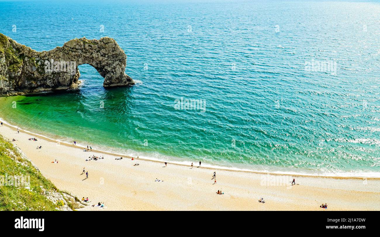 A sandy beach with beautiful cliffs in the water Stock Photo - Alamy