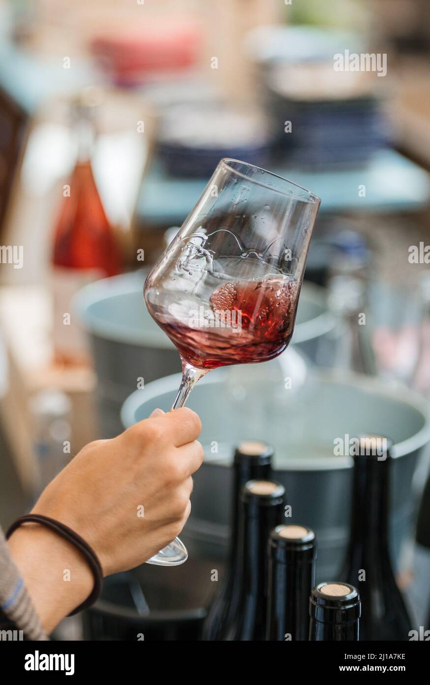 hand with a glass of red wine at a wine tasting Stock Photo - Alamy