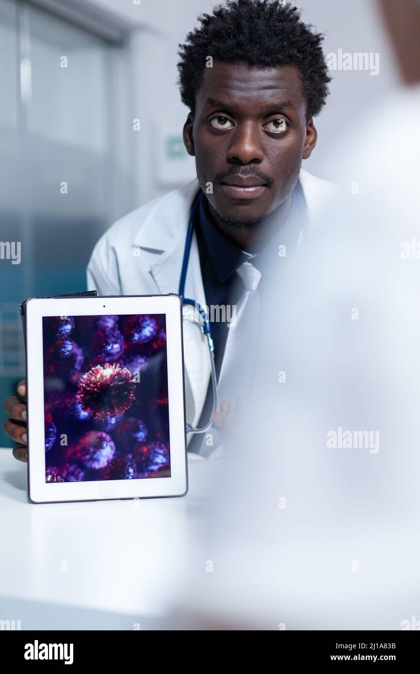 Hospital expert virologist showing symptoms of virus and effects of ...