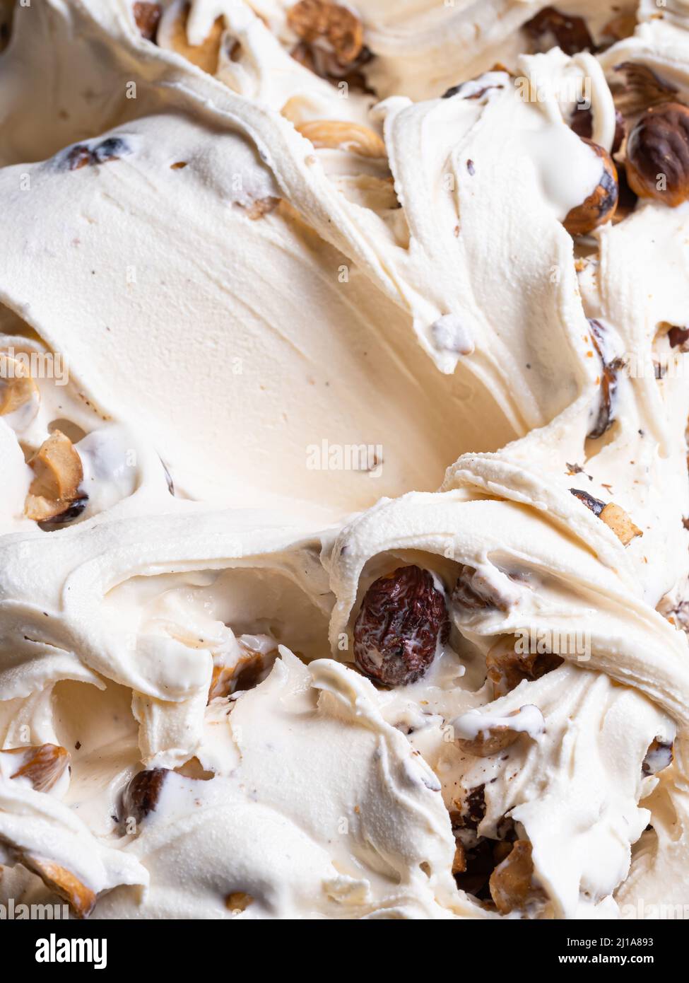 Frozen Hazelnut flavour gelato - full frame detail. Close up of a white ...