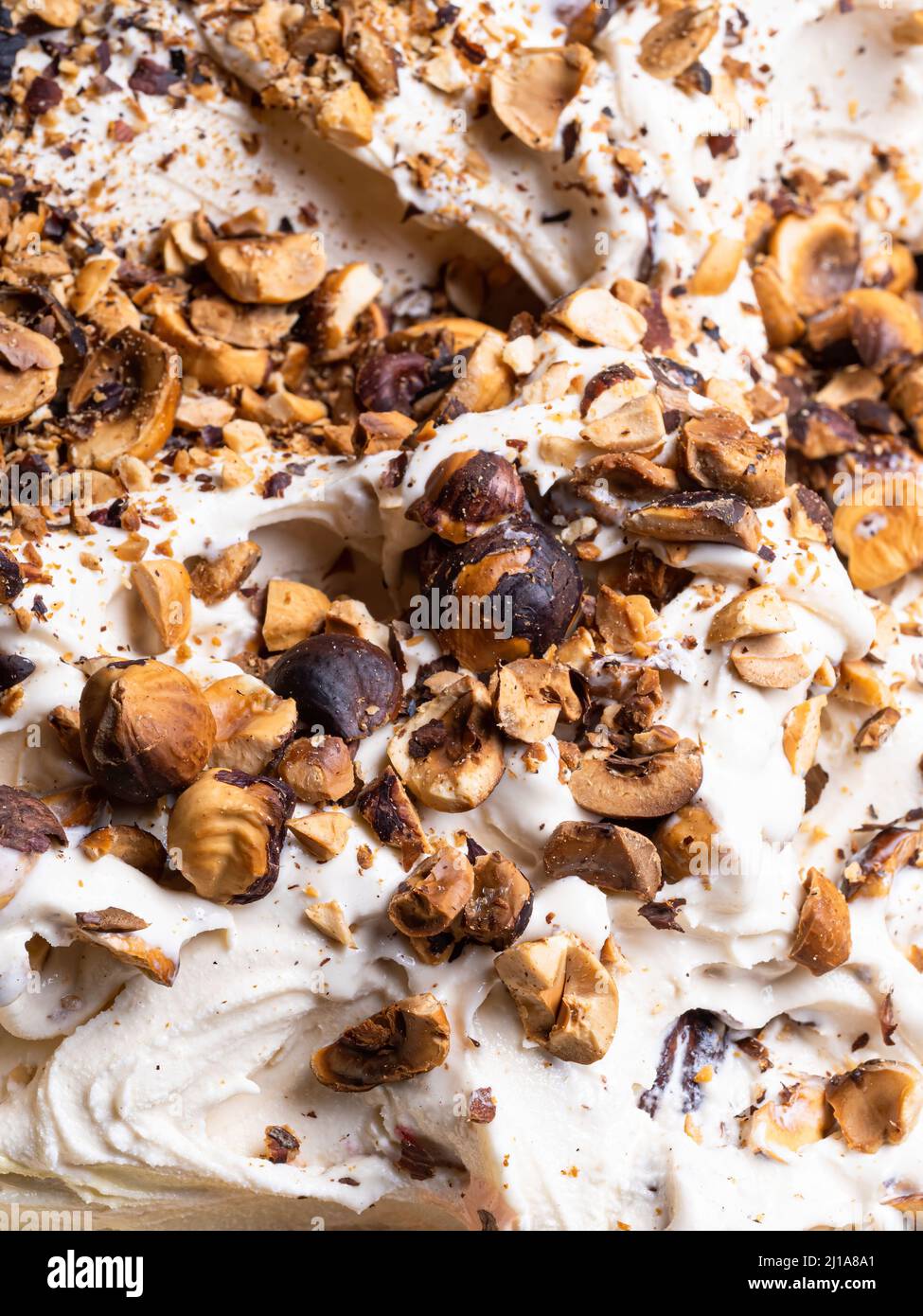 Frozen Hazelnut flavour gelato - full frame detail. Close up of a white ...
