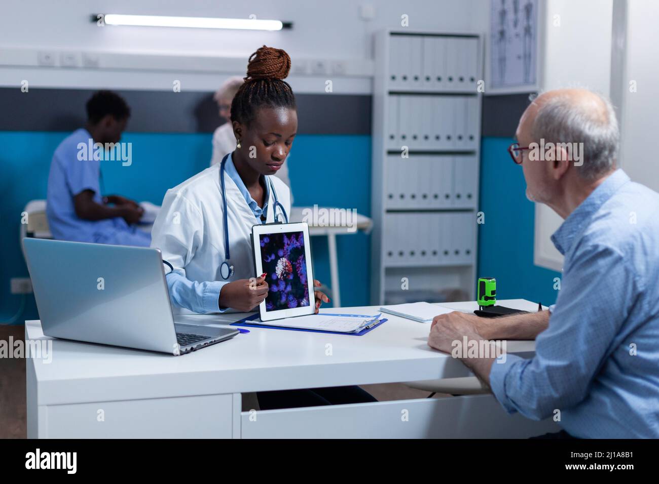 Expert virologist presenting senior man symptoms and health risks of ...