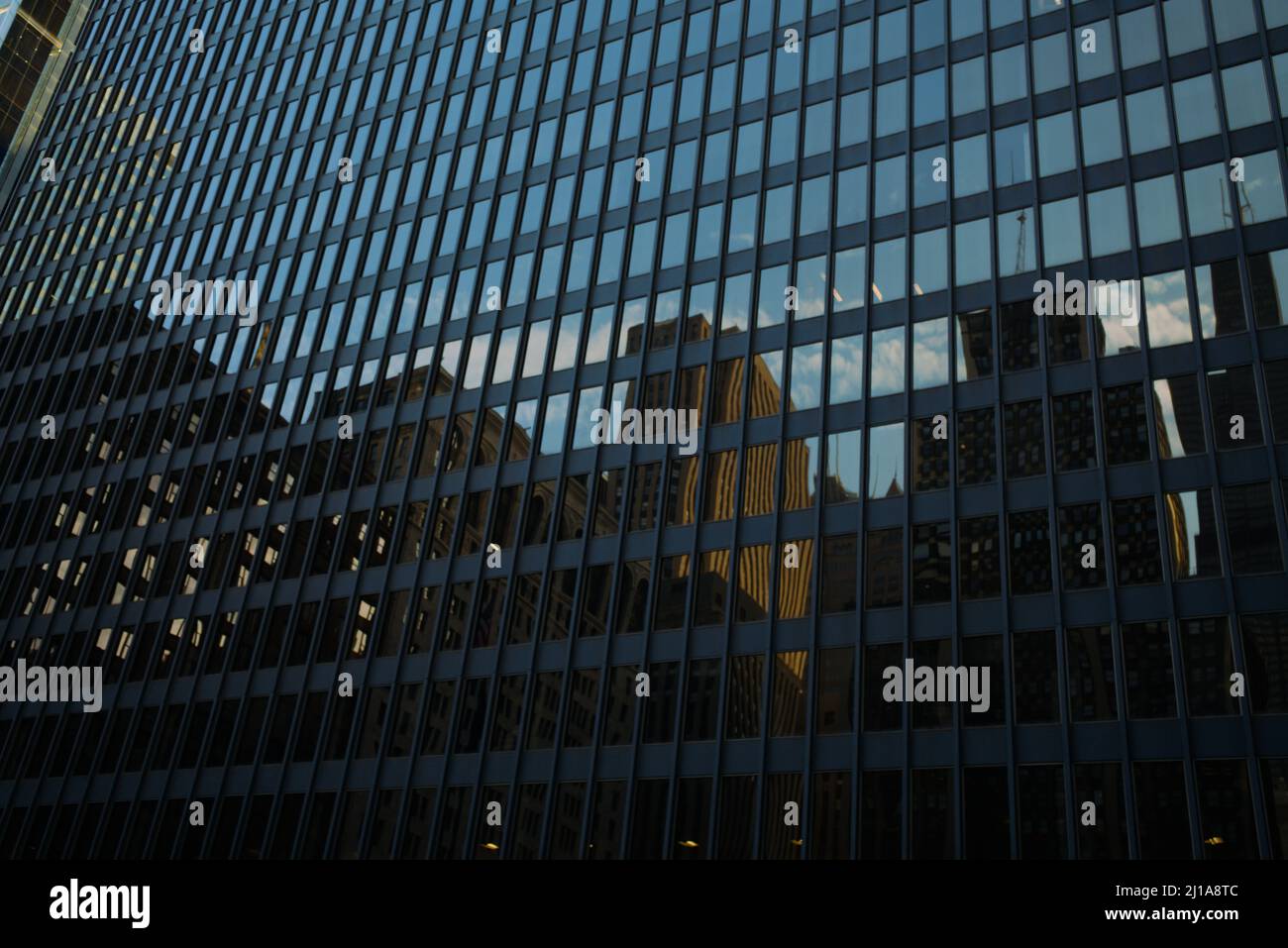 A beautiful shot of buildings reflection on the rectangular glazed ...