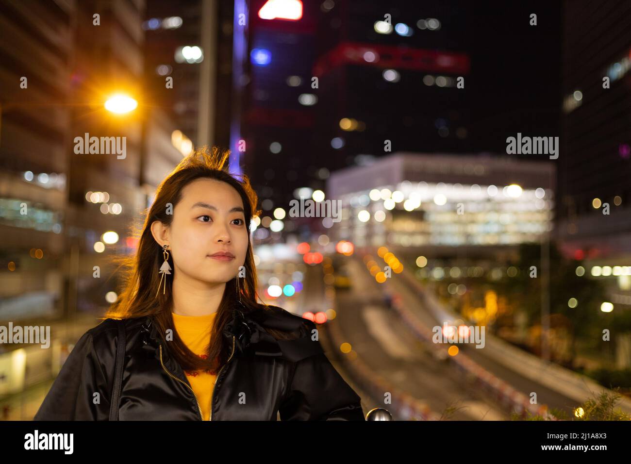 pretty young university student girl in Central, Hong Kong with night ...