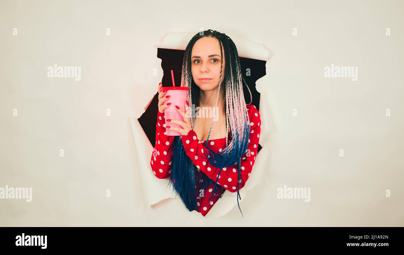 Female bartender with dreadlocks and cup of sweet beverage peeking ...