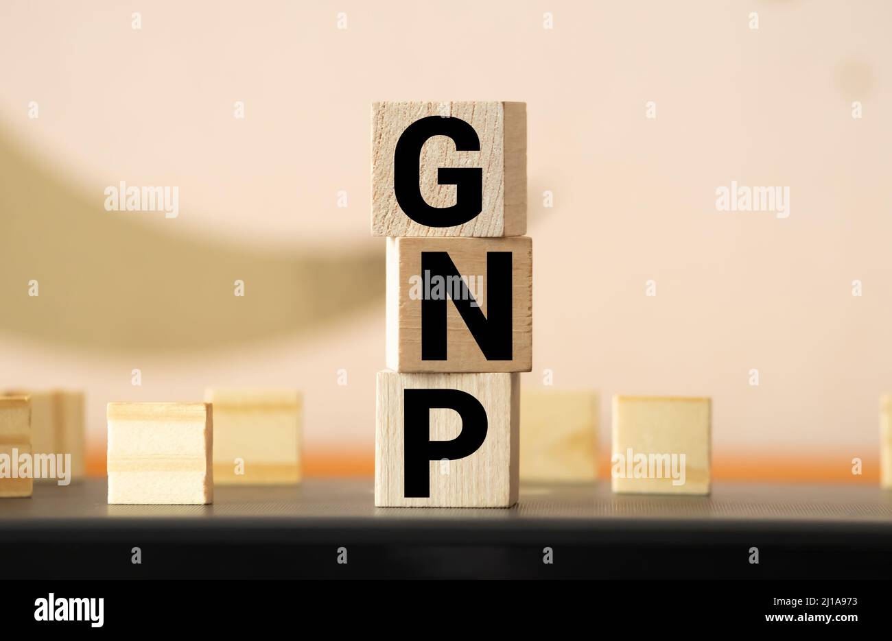 GNP Gross Domestic Product word made with wooden blocks on grey blue ...