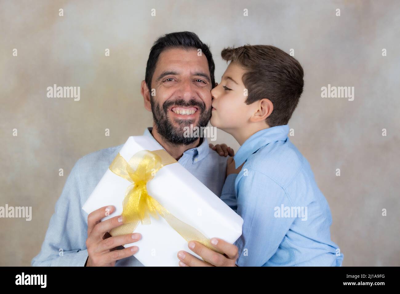 Little boy giving a gift to his father on Fathers Day Stock Photo - Alamy
