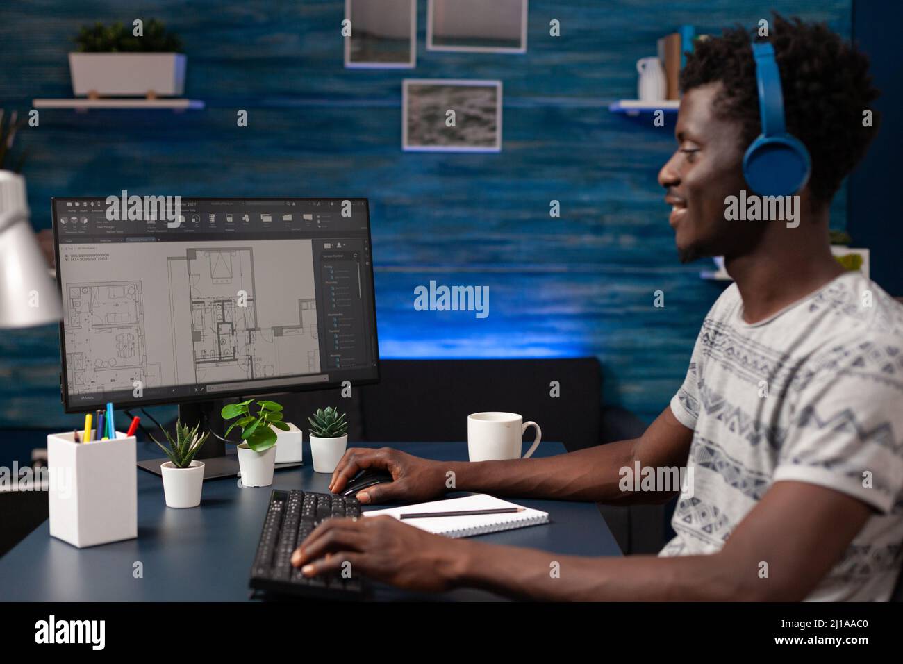 Real estate technician sitting at desk in front of computer analyzing ...