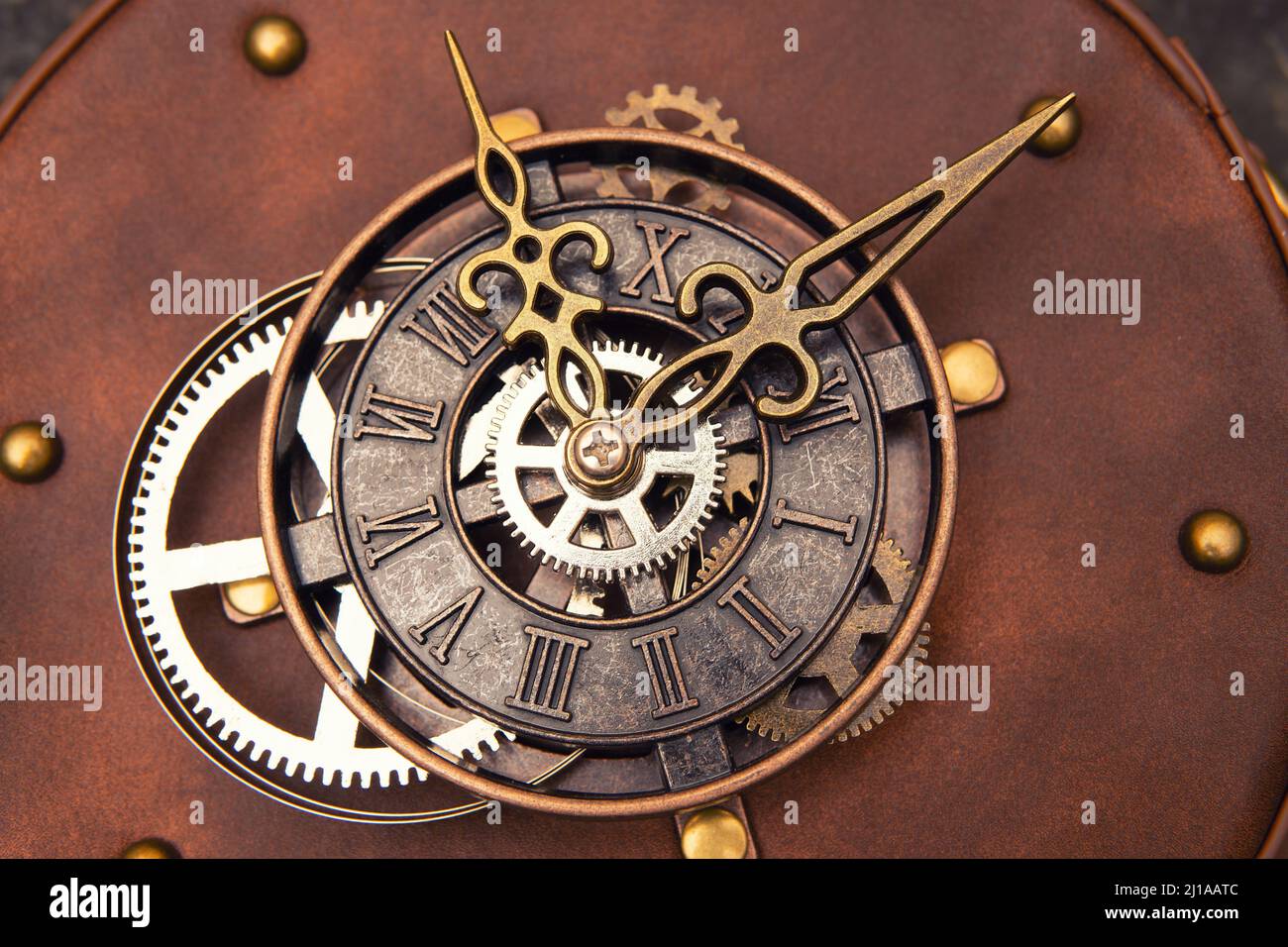Close-up of a clock mechanism with cogs, watch face and hands as ...