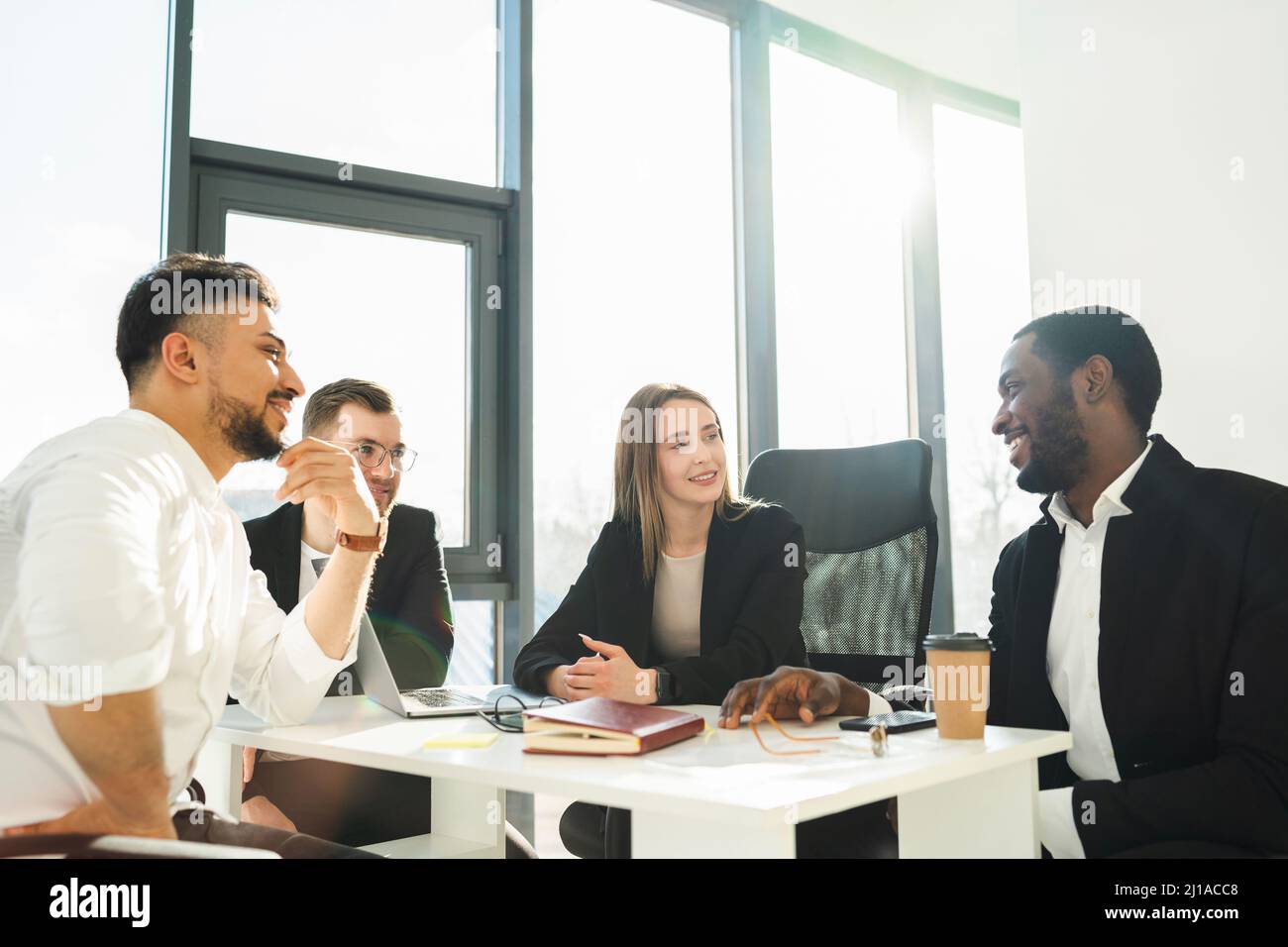 Multiracial office workers at morning meeting in office Stock Photo - Alamy