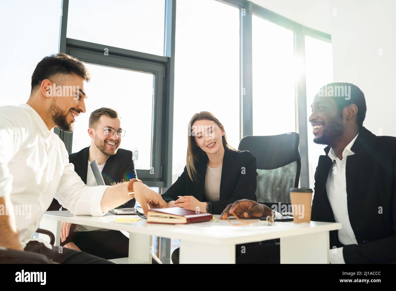 Group of multiracial company workers in formal wear having a meeting in ...