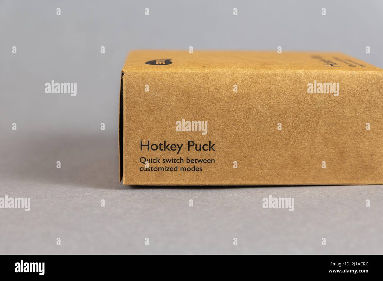 Brown cardboard box with Hotkey Puck for Benq monitor on a gray ...