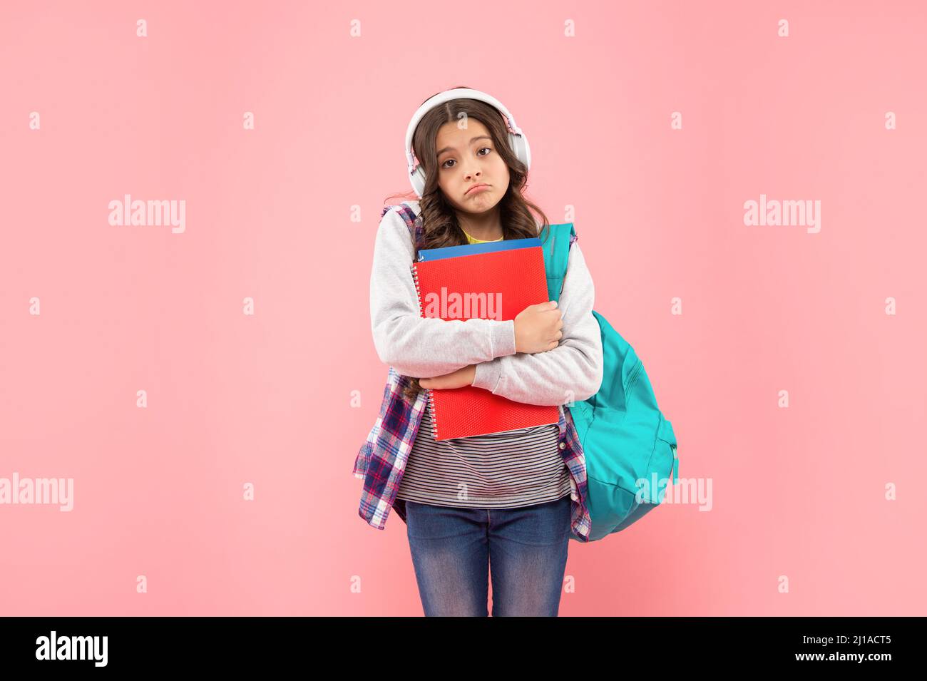 sad child in earphones hold workbook and backpack. online education ...