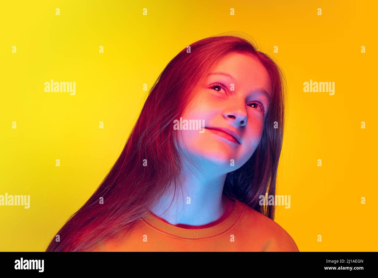 Close-up portrait of beautiful teen girl posing with dreamy expression ...