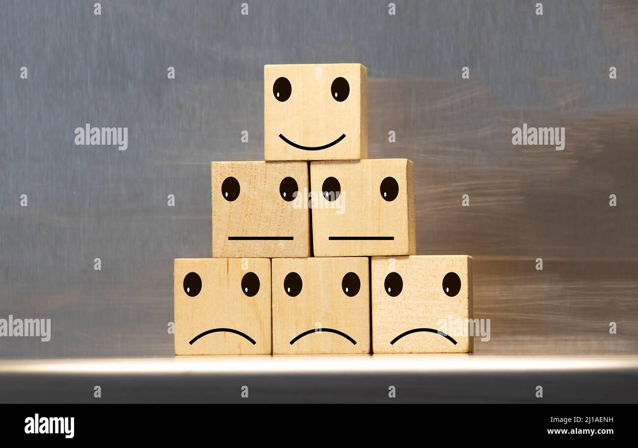 Customer chooses a smiley face on wood cube block, Business service ...