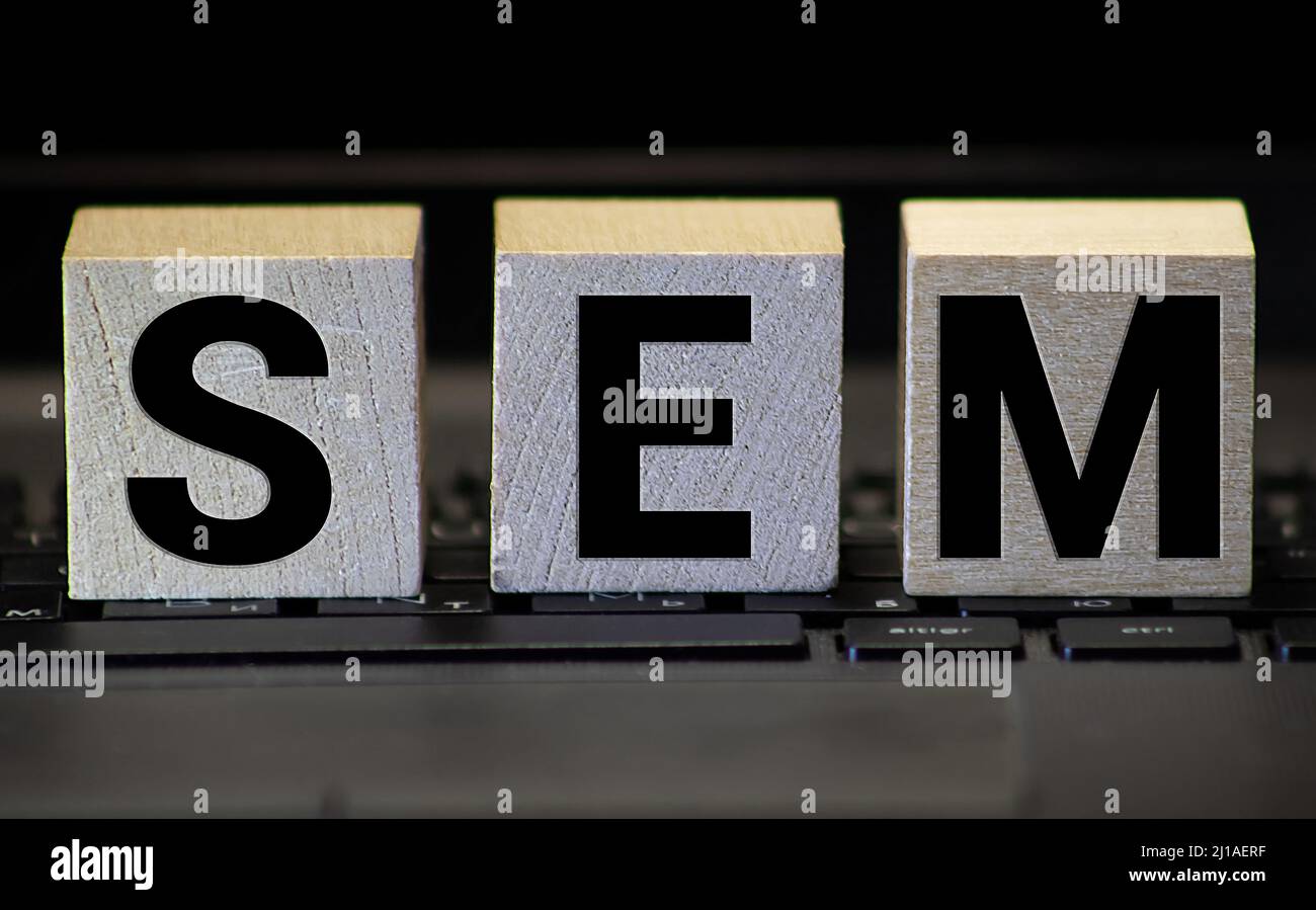 3 Toy Wood Blocks With Letters: SEM On a Wooden Table With Light Grey ...