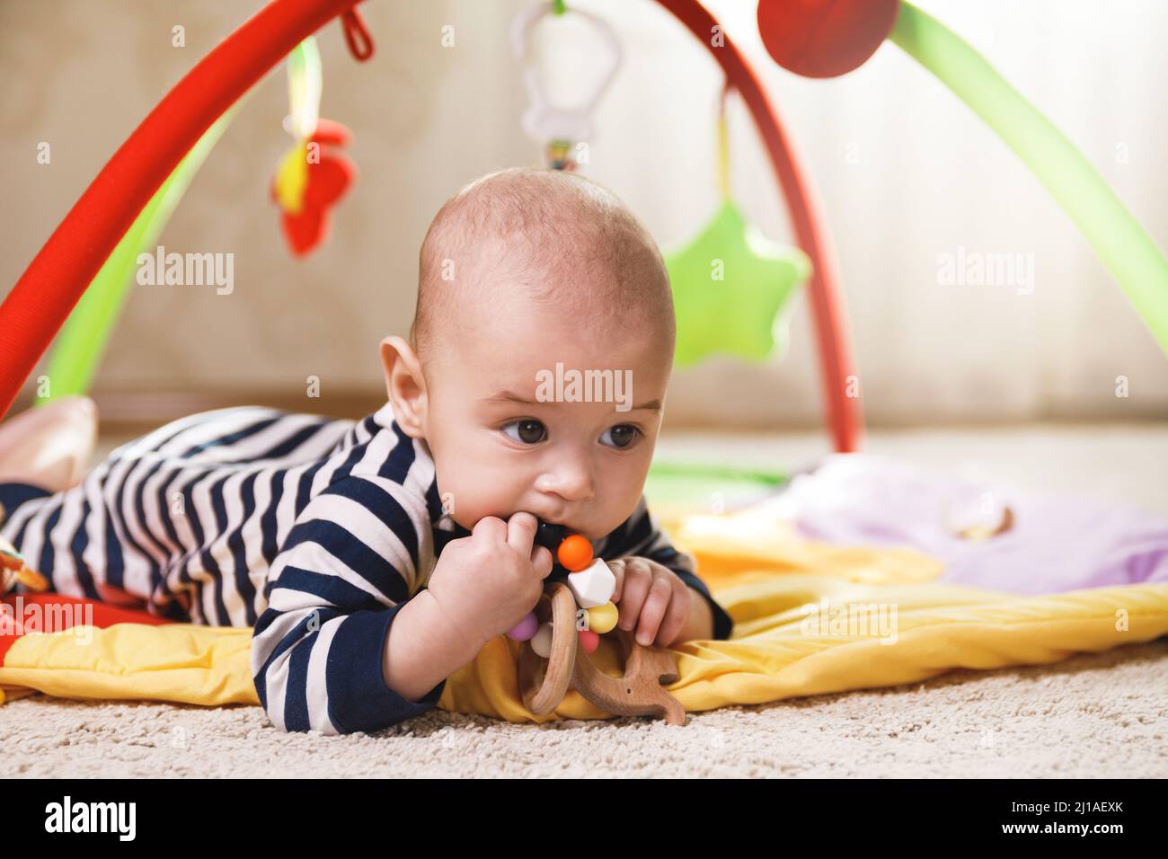 Cute baby is playing on the activity mat Stock Photo - Alamy