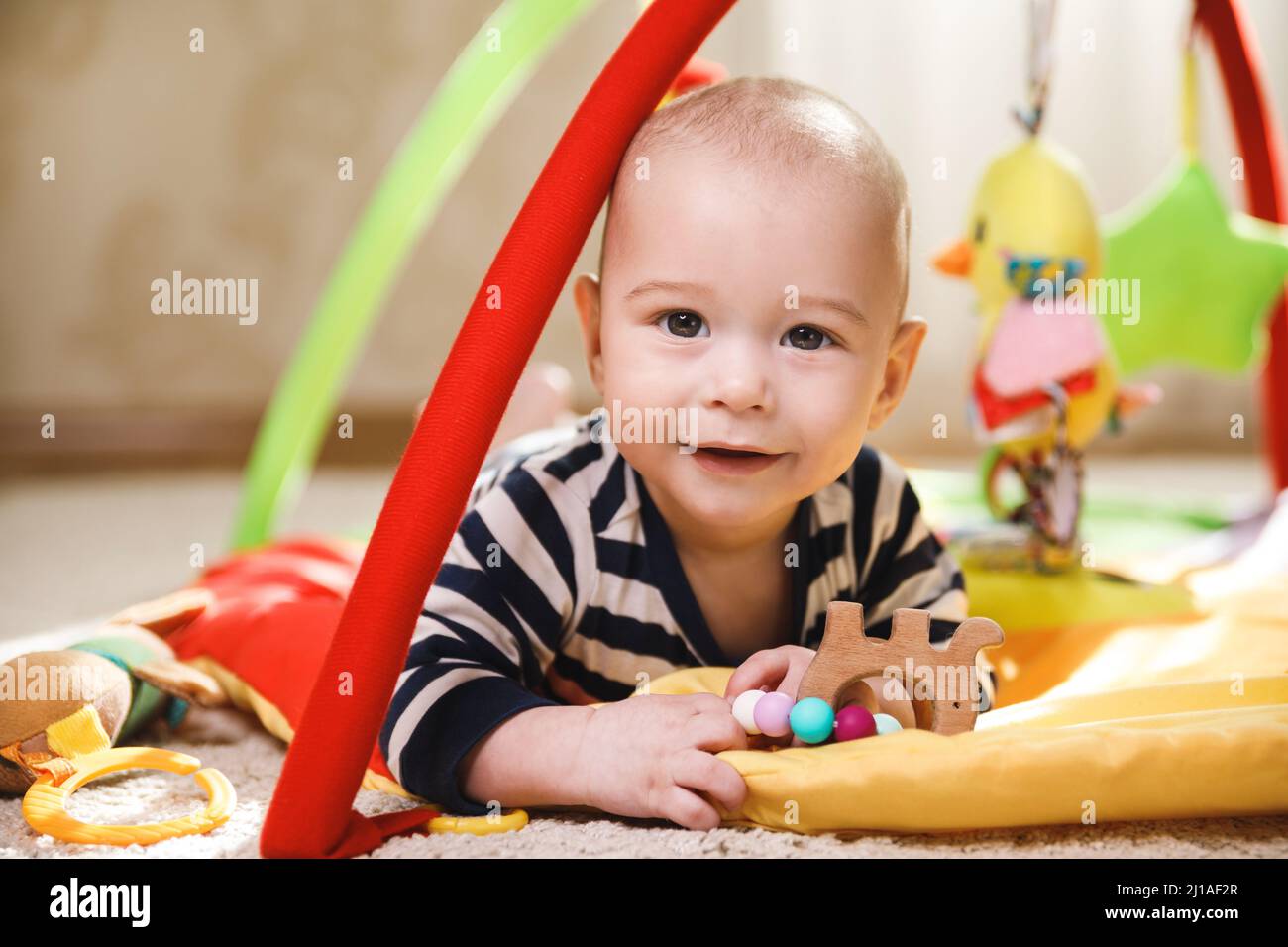 Cute baby is playing on the activity mat Stock Photo - Alamy