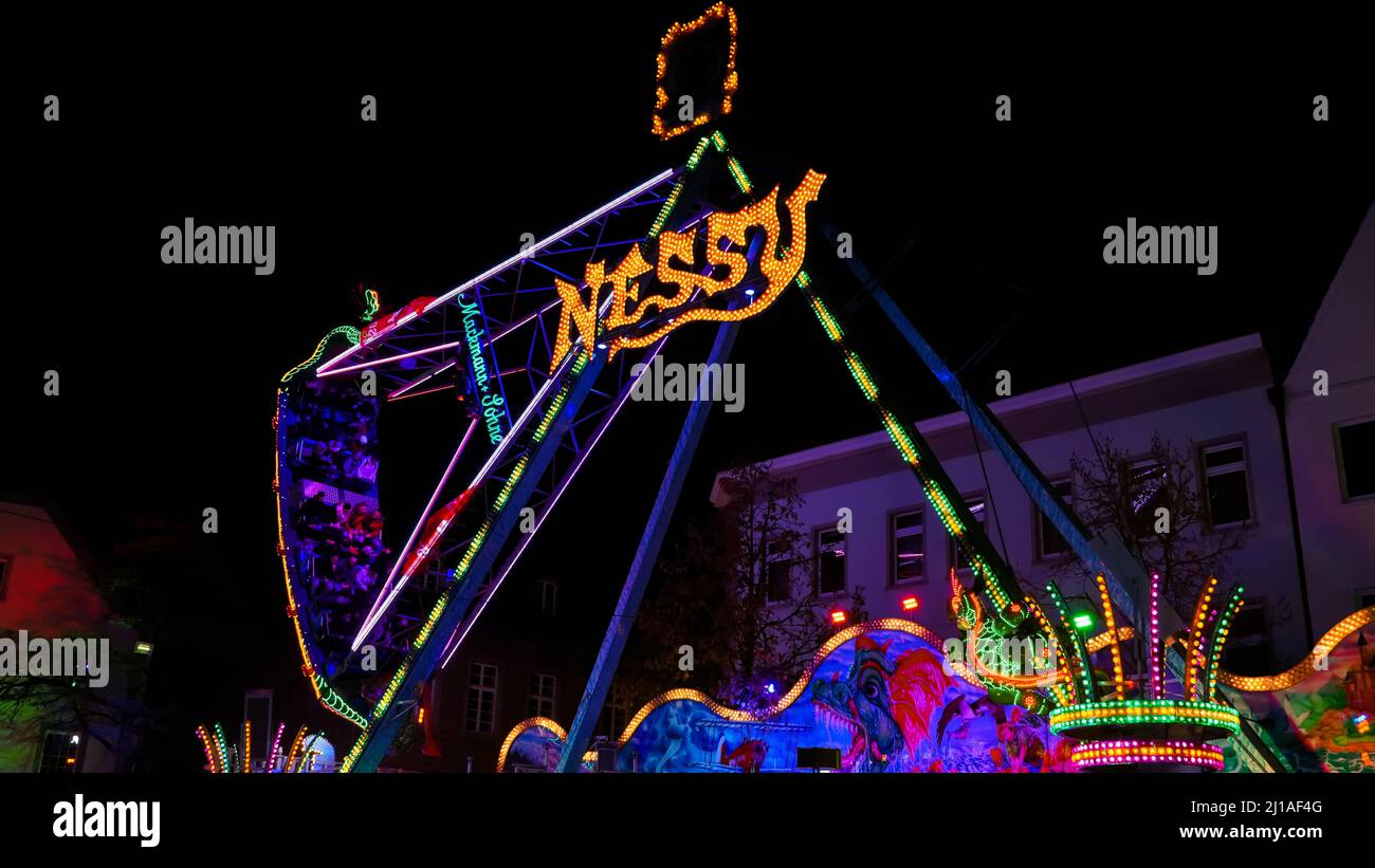 Boat swing at a funfair by night Stock Photo - Alamy