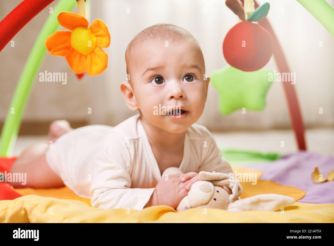 Cute baby is playing on the activity mat Stock Photo - Alamy
