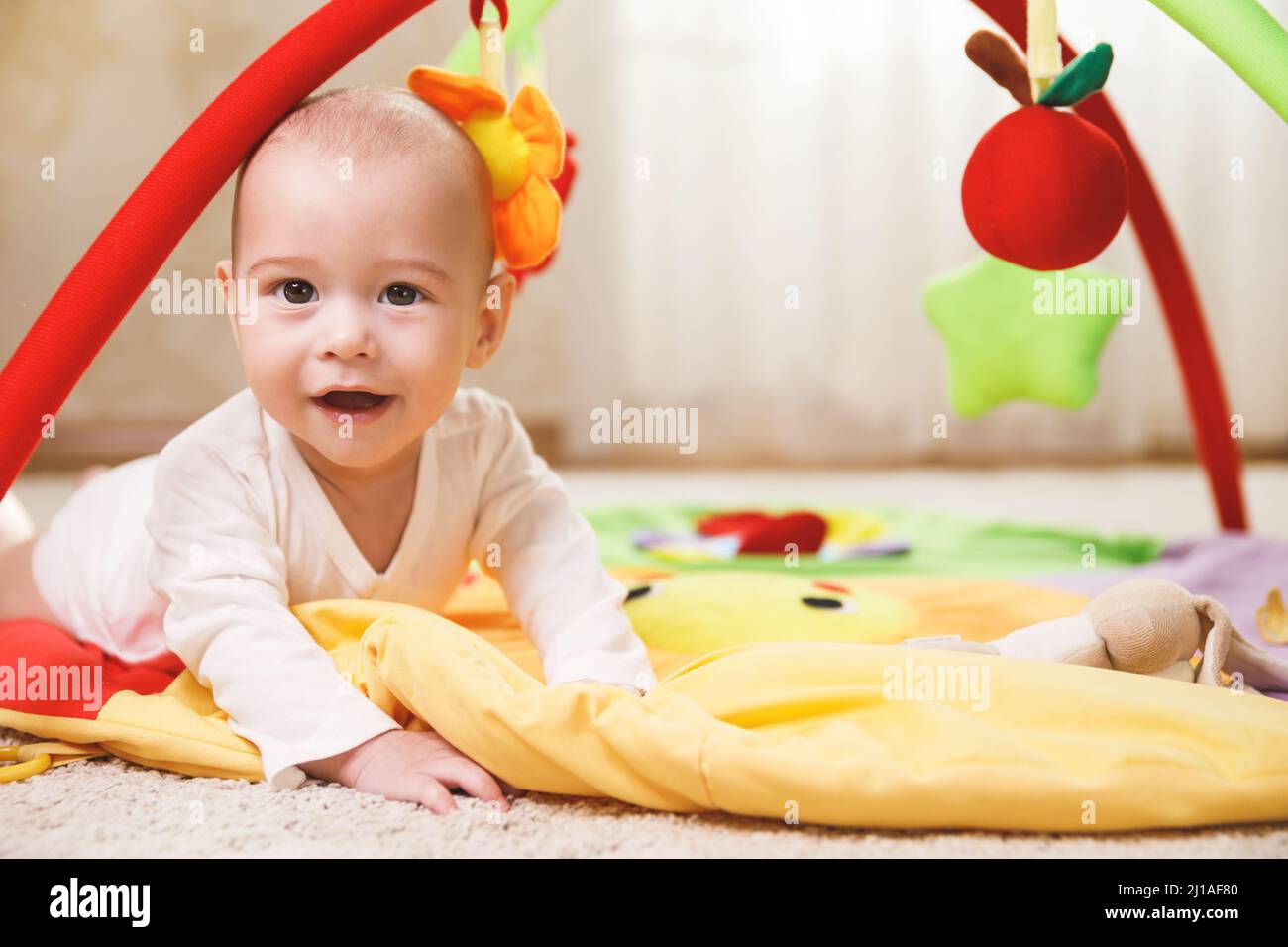 Cute baby is playing on the activity mat Stock Photo - Alamy
