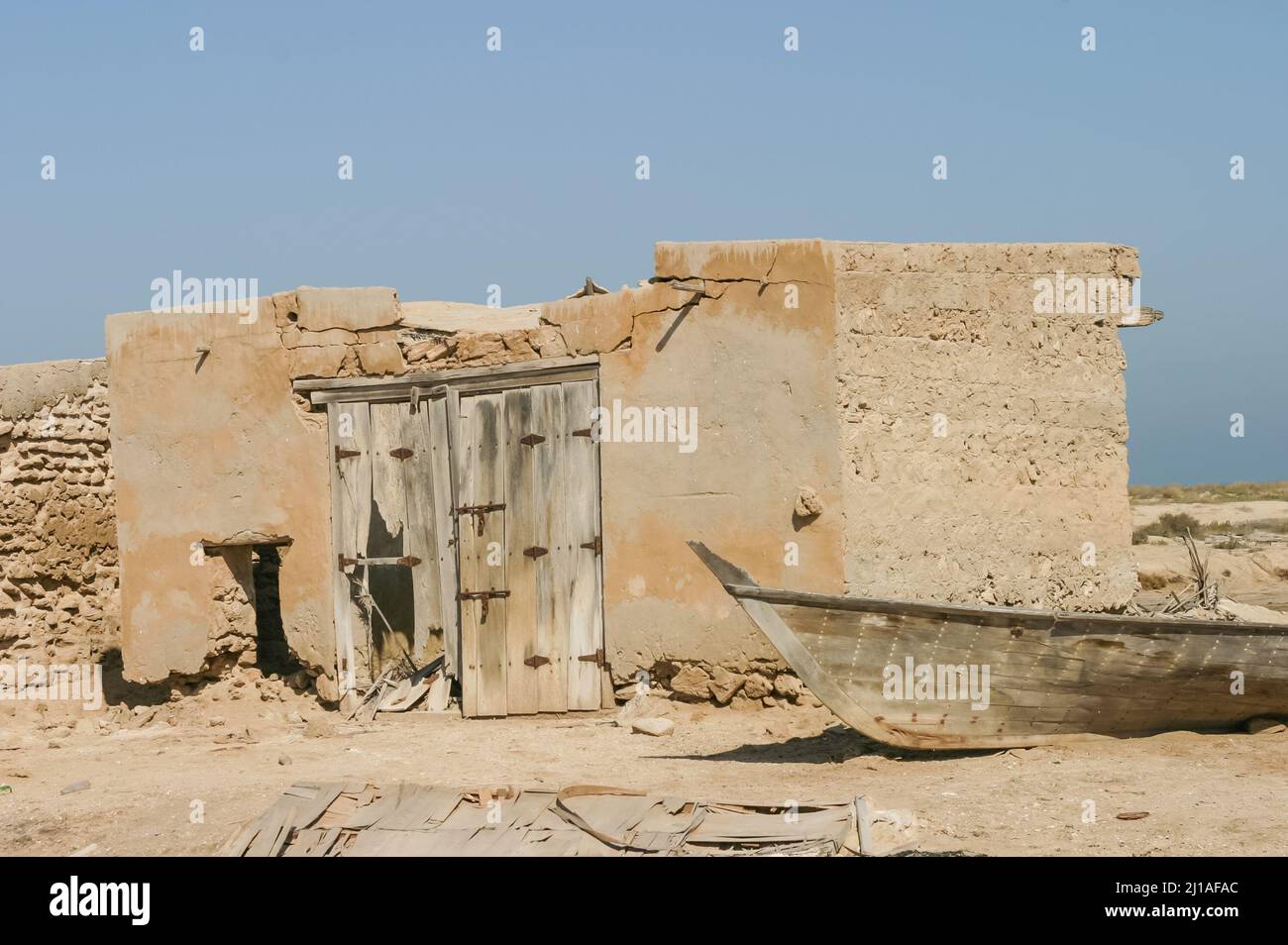 An old shed and fishing boat in Al Jazirat Al Hamra, a town to the ...
