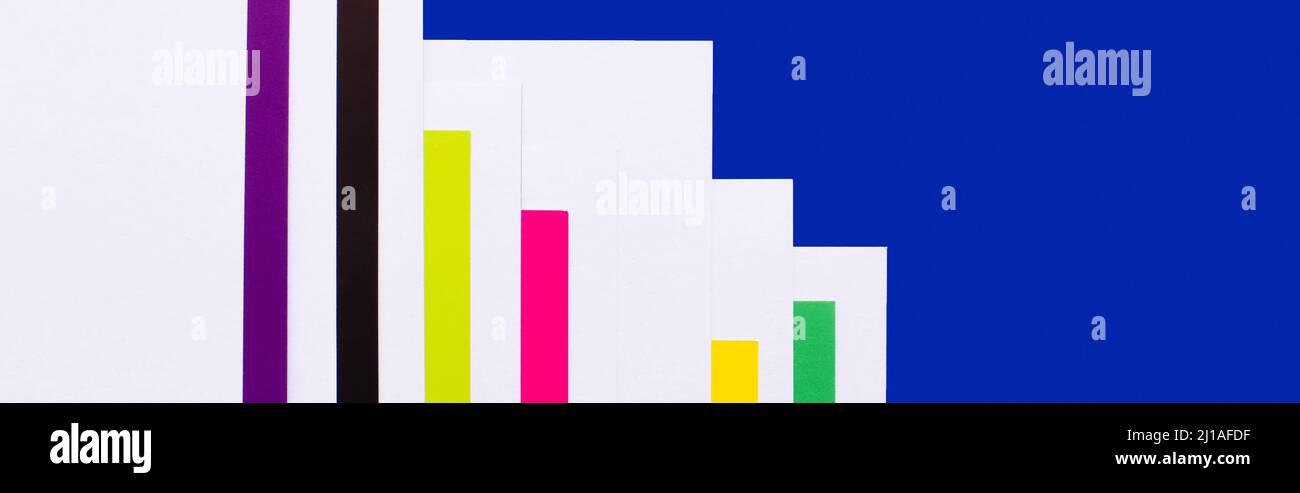 bright colored paper sheets on blue background, banner Stock Photo - Alamy