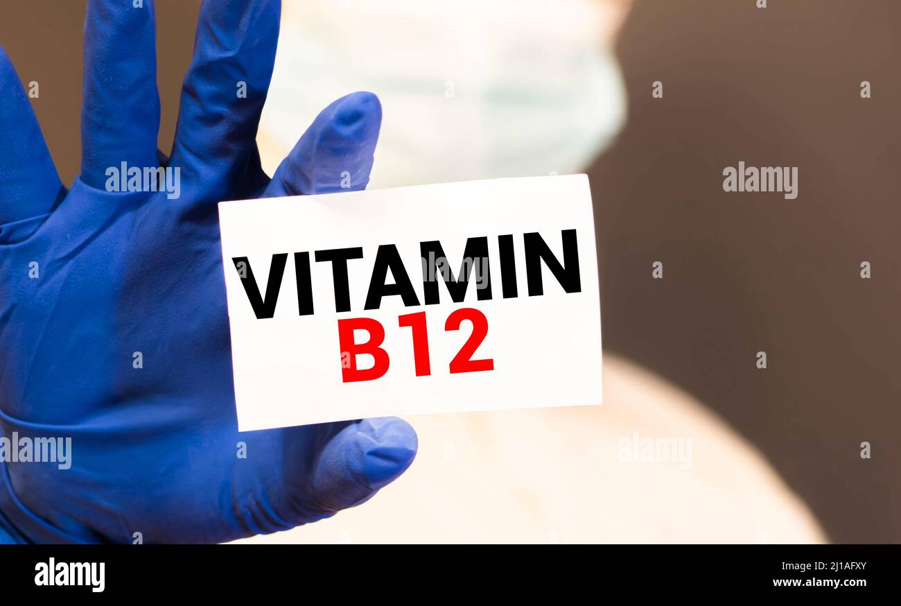Doctor holding a card with Vitamin B12, Medical concept Stock Photo - Alamy