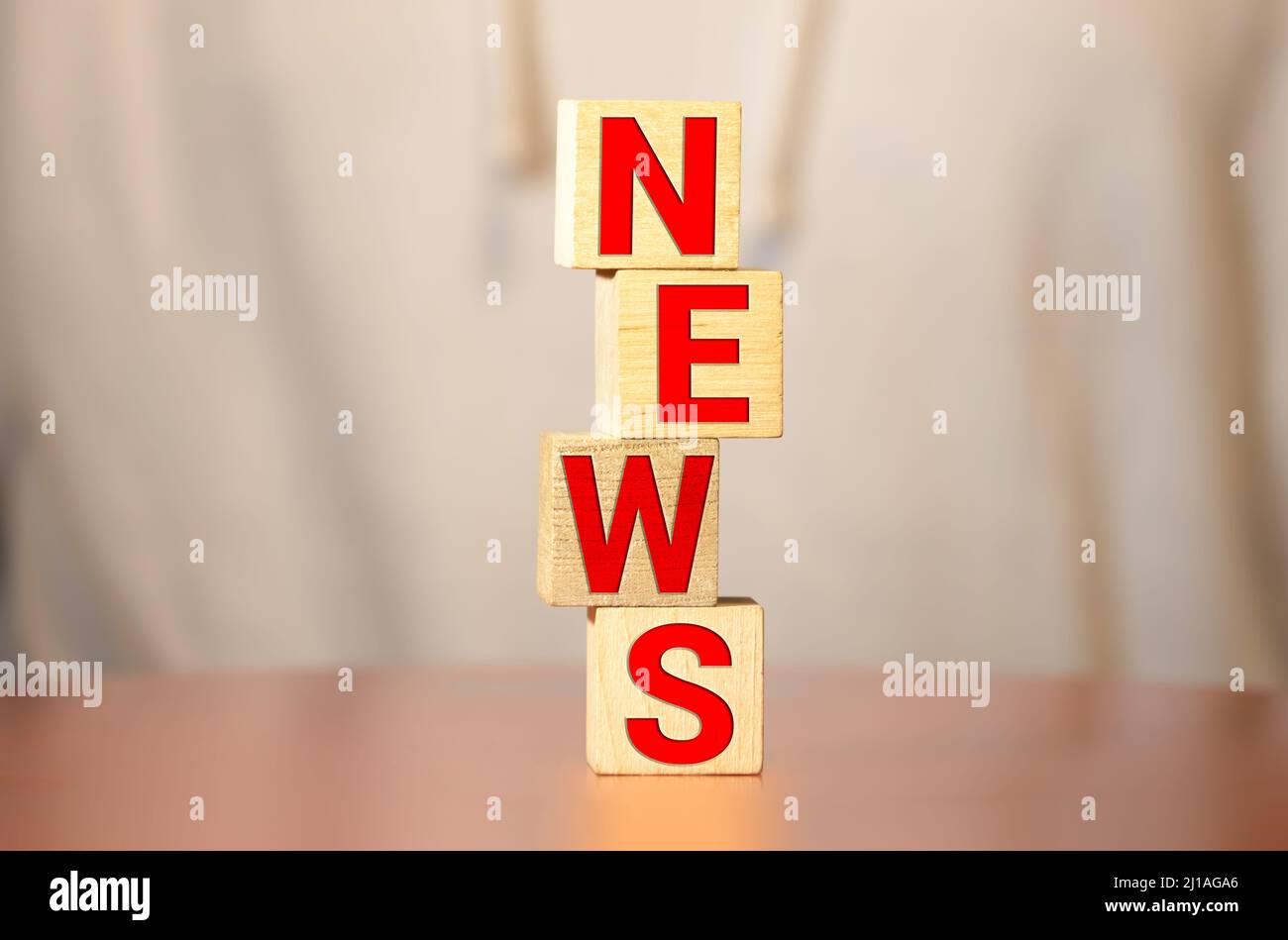 NEWS word on wooden block and newspaper Stock Photo - Alamy