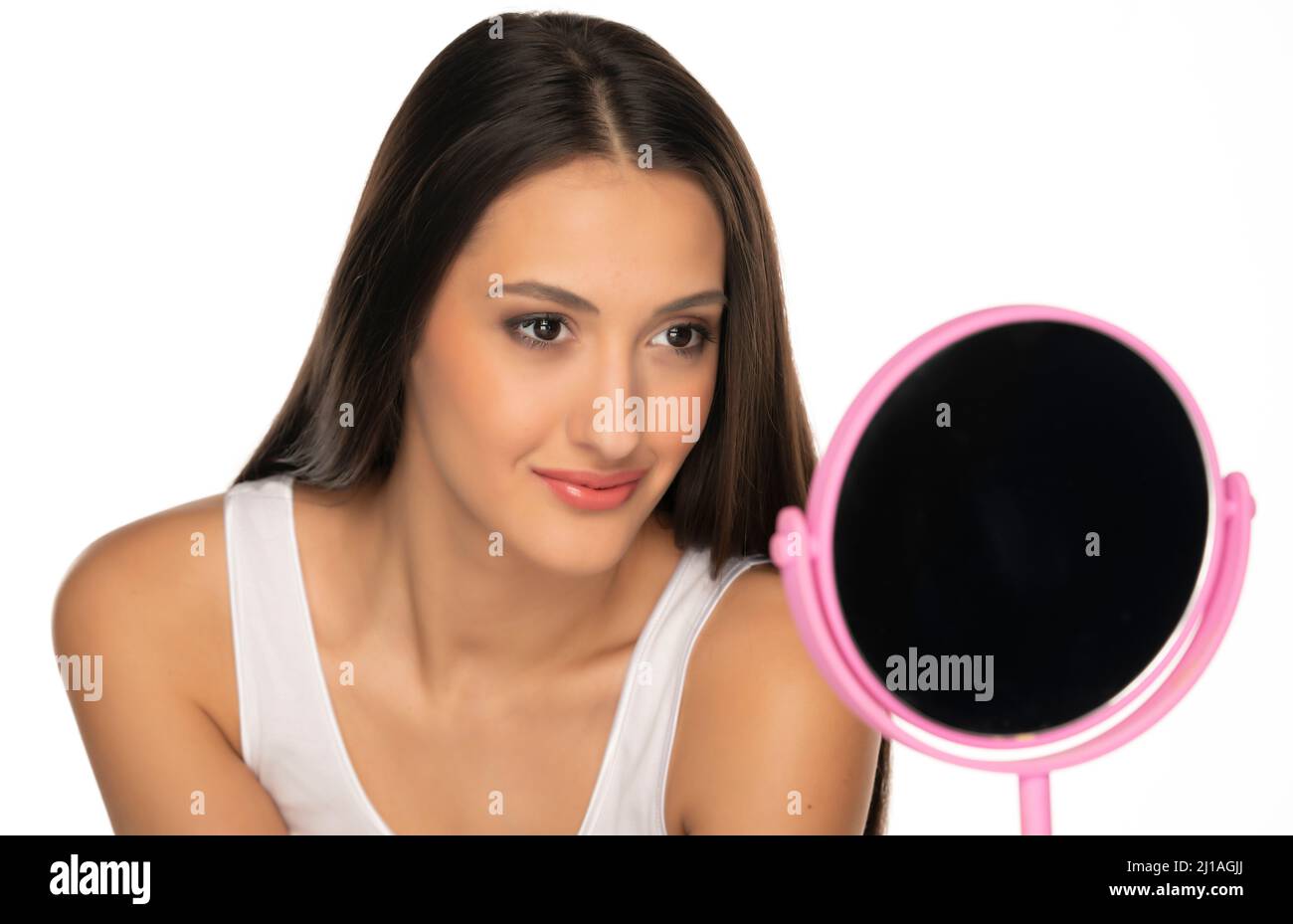 portrait of a young satisfied woman with long black hair, look at her ...