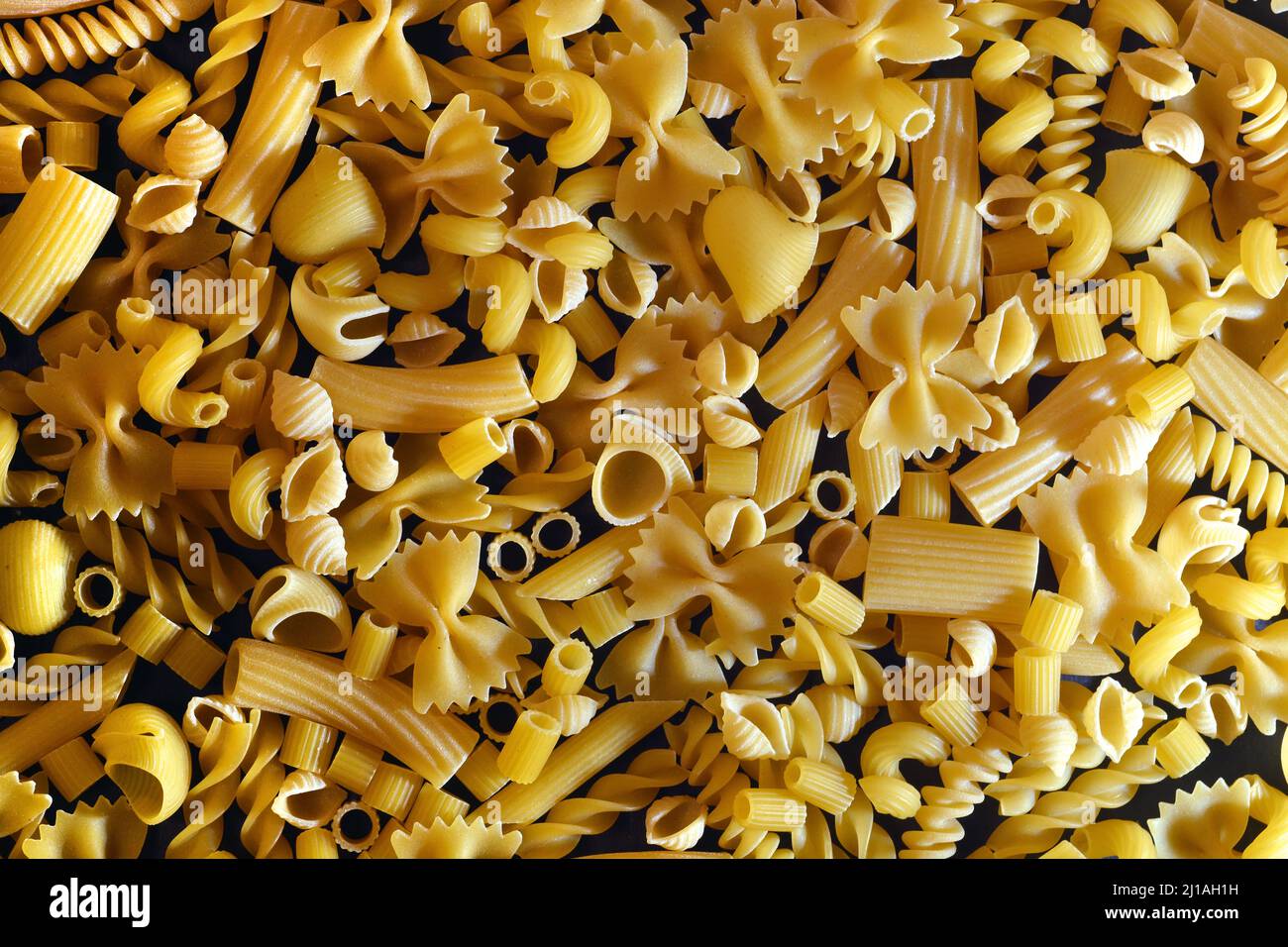 Food texture, assortment of different uncooked types of Italian Pasta ...