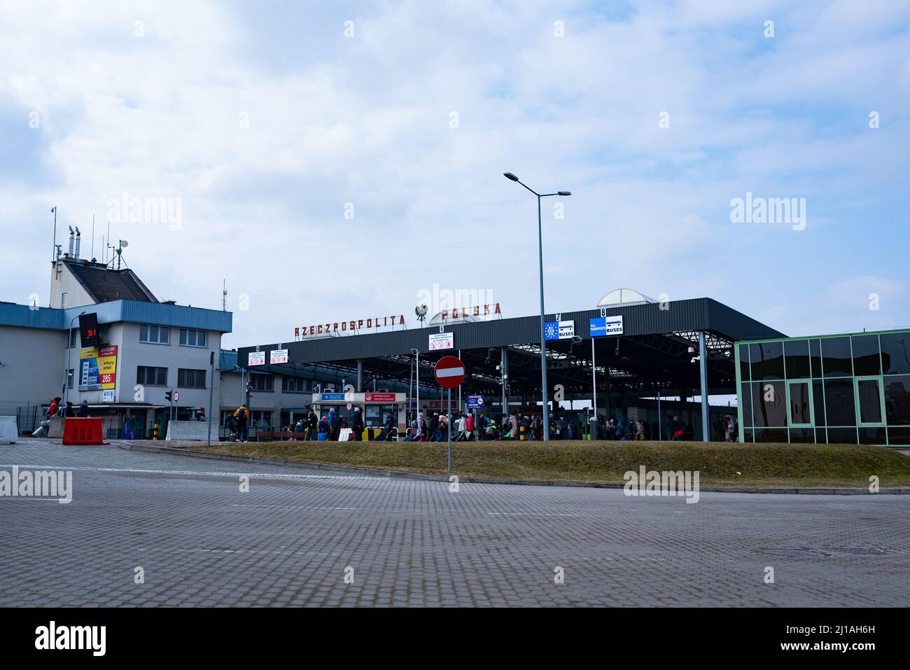 Refugees are seen entering Poland a border crossing between Poland and ...