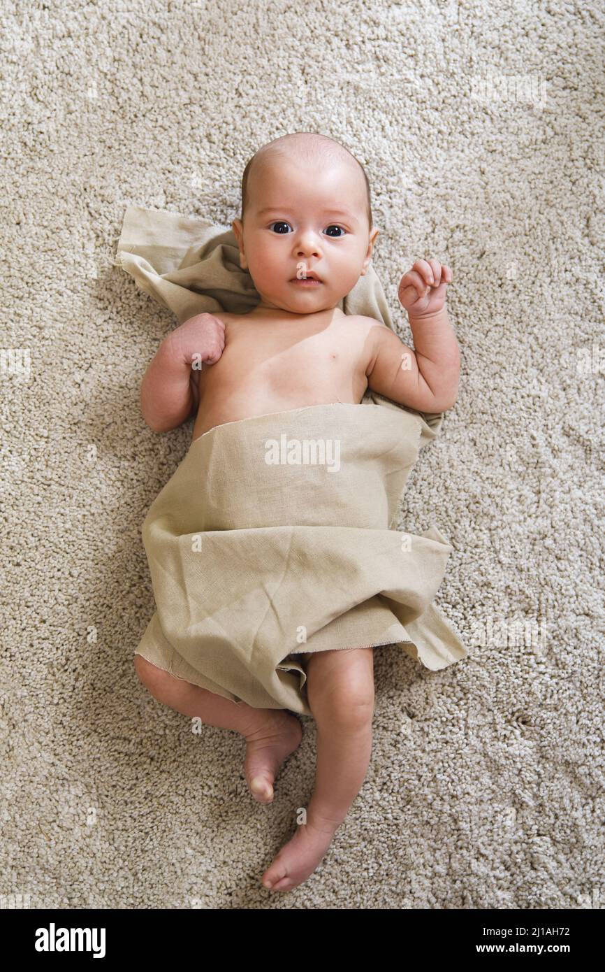 Cute little baby covered with piece of linen fabric Stock Photo - Alamy