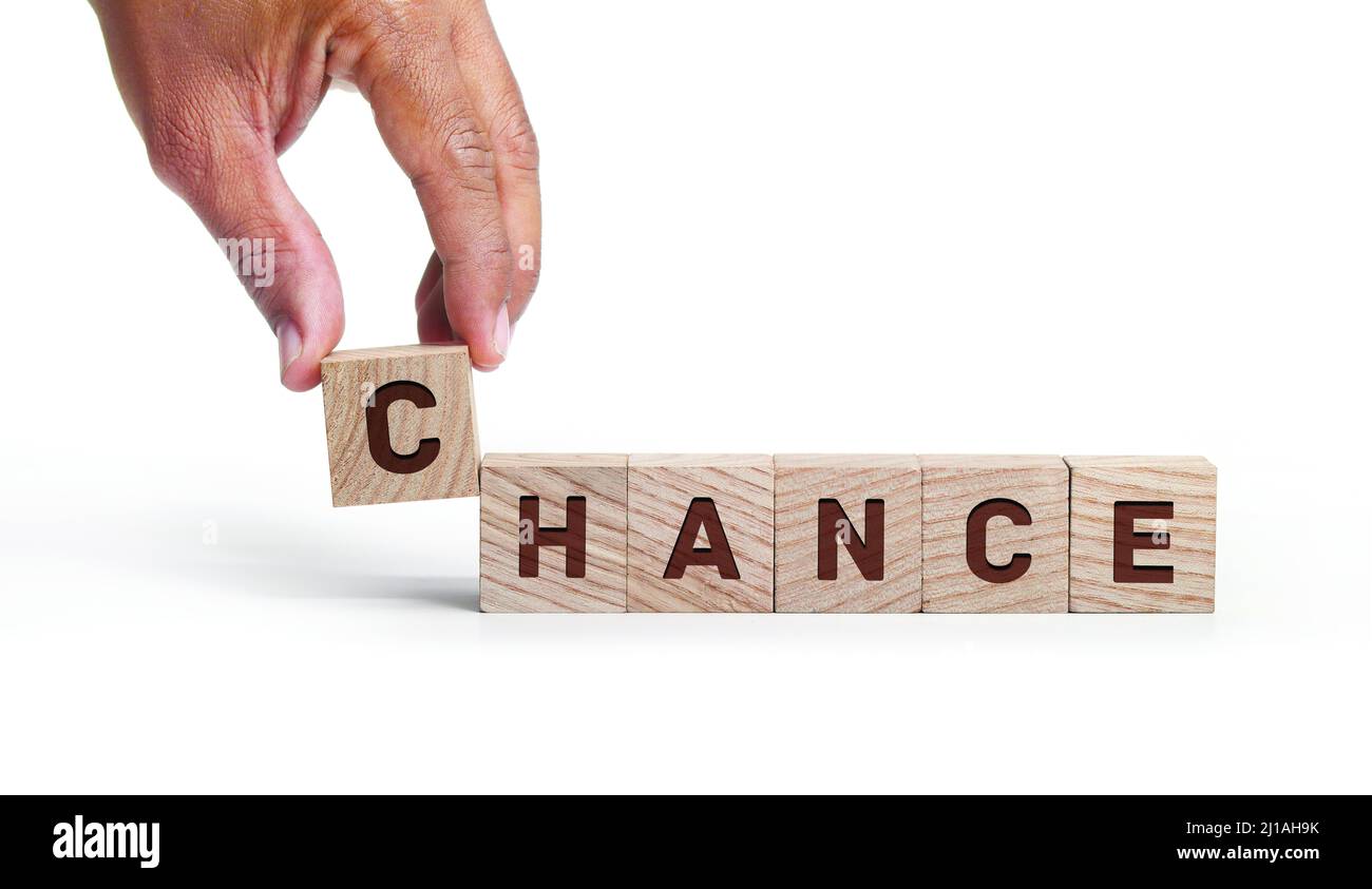 Hand putting wooden cubes block which print screen chance wording ...