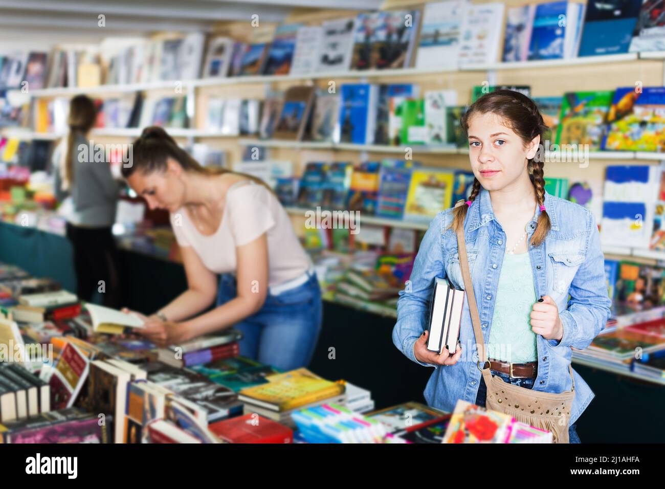 Teenage girl buying books Stock Photo - Alamy