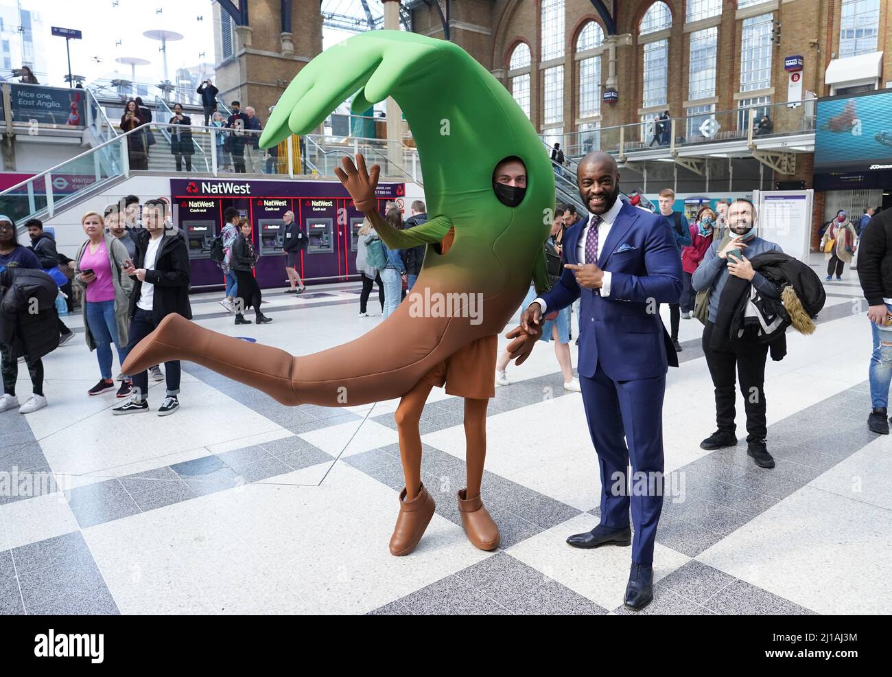 Tim Campbell stands next to a logo that was designed in the first ...